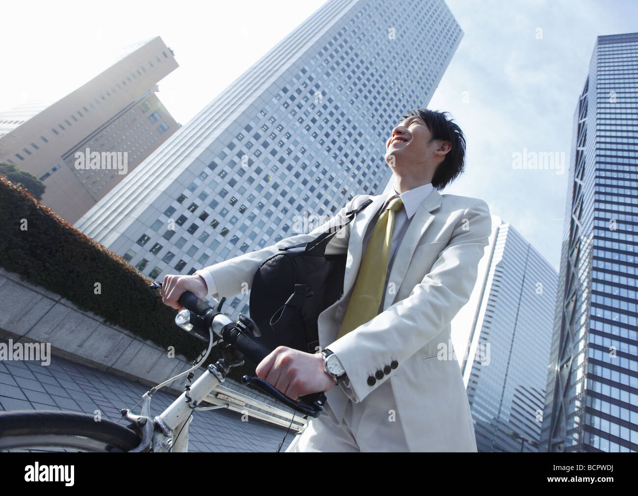 Businessman pushing his bicycle Stock Photo - Alamy