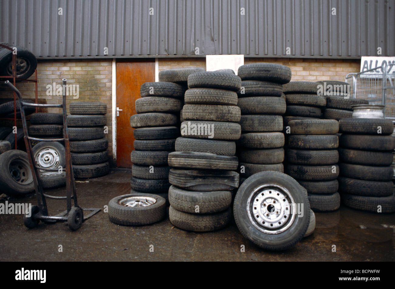 Pile Of Used Tyres In A Scrapyard Stock Photo - Alamy
