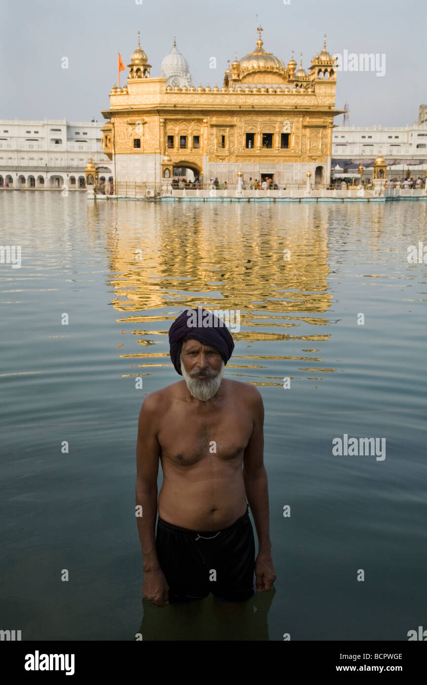 Sikh man bathes in the waters – the Sarovar (water tank) –around the ...