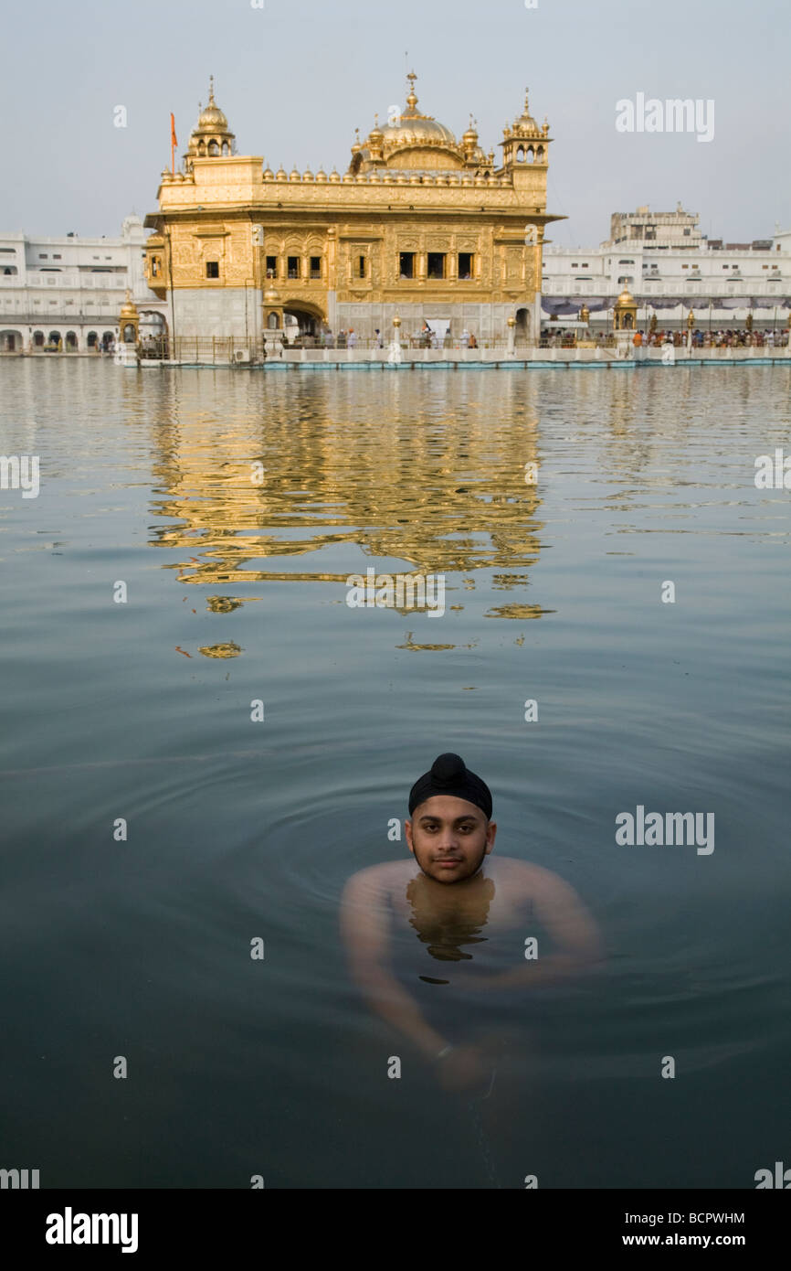 Sikh man bathes in the waters – the Sarovar (water tank) –around the ...
