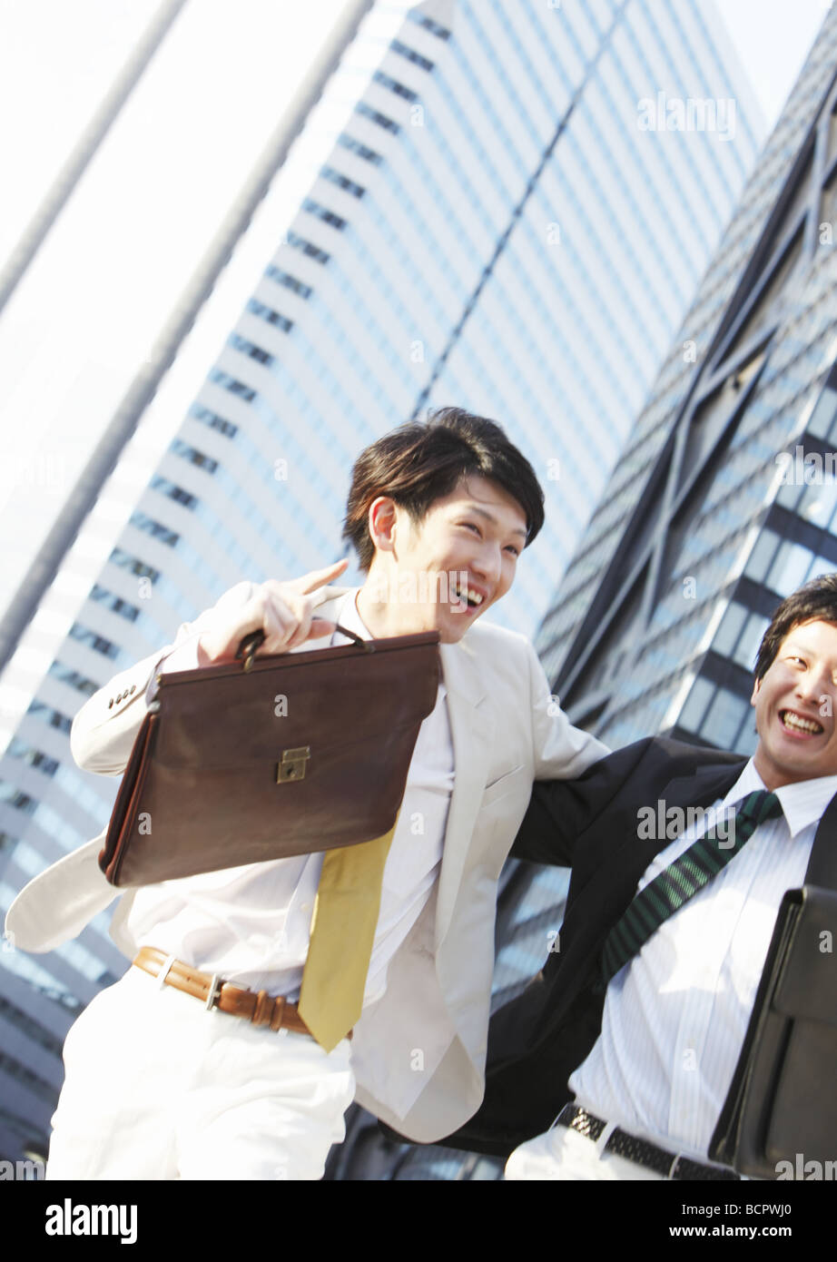 Businessmen with arms around shoulders Stock Photo - Alamy