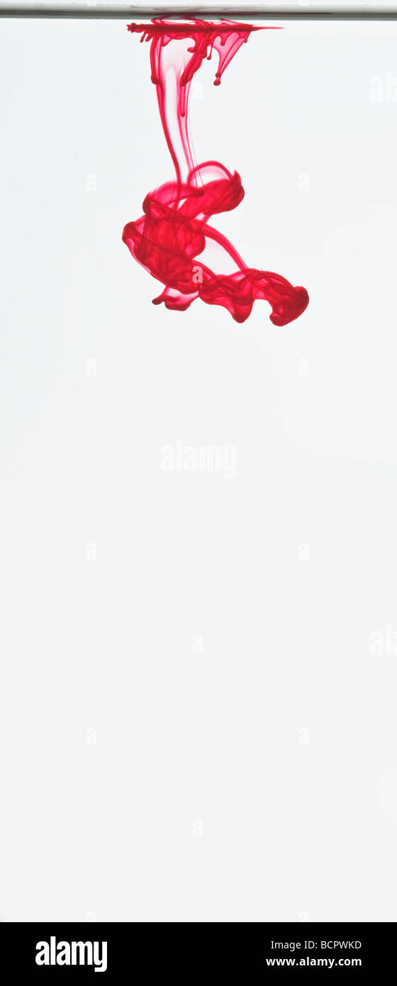 Colored food dye droplets floating in water to make abstract patterns ...