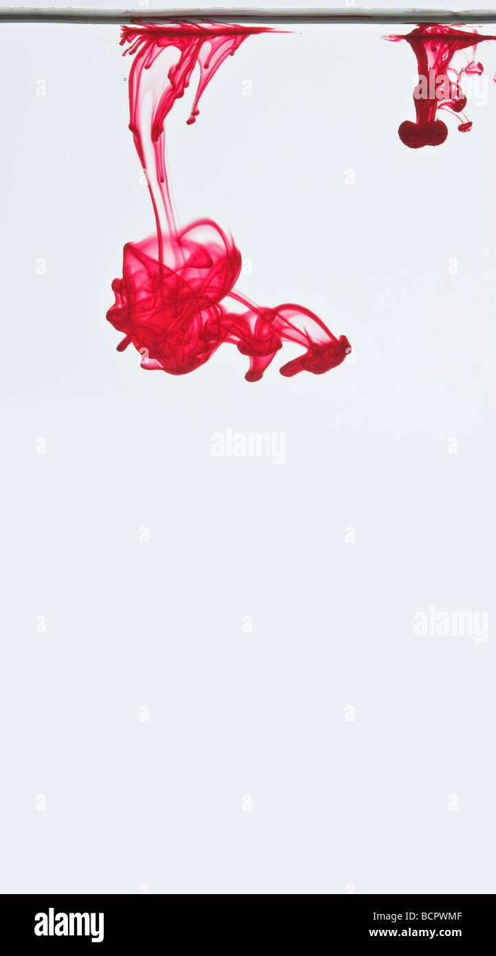 Colored food dye droplets floating in water to make abstract patterns ...