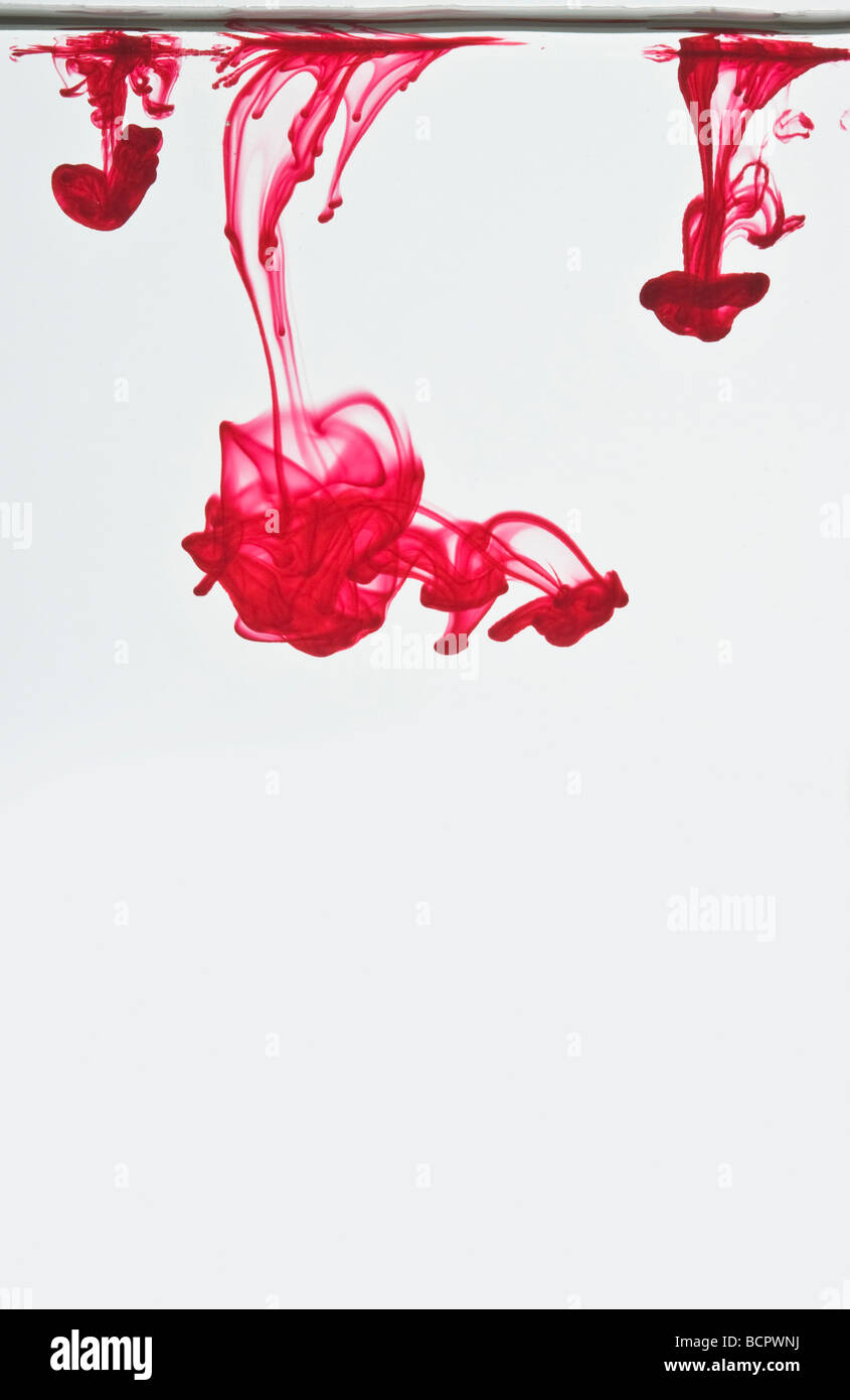 Colored food dye droplets floating in water to make abstract patterns ...