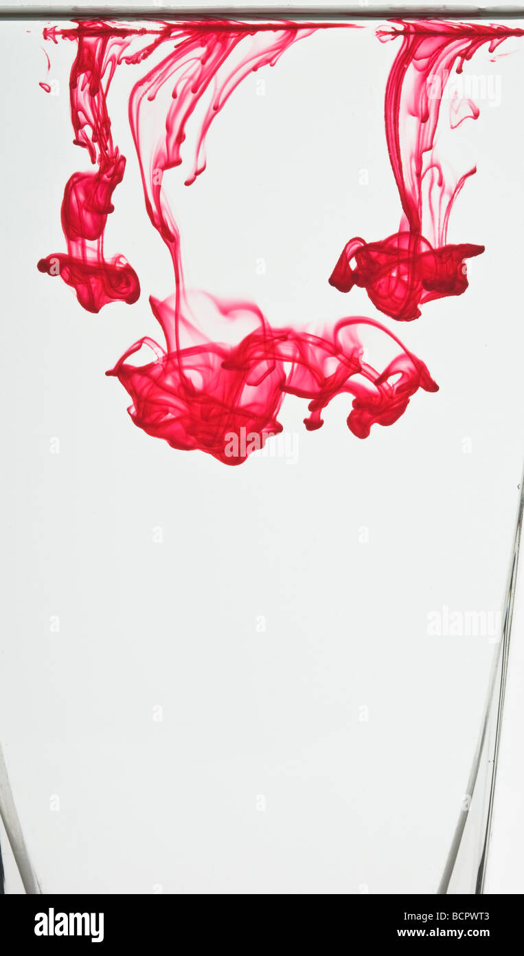 Colored food dye droplets floating in water to make abstract patterns ...