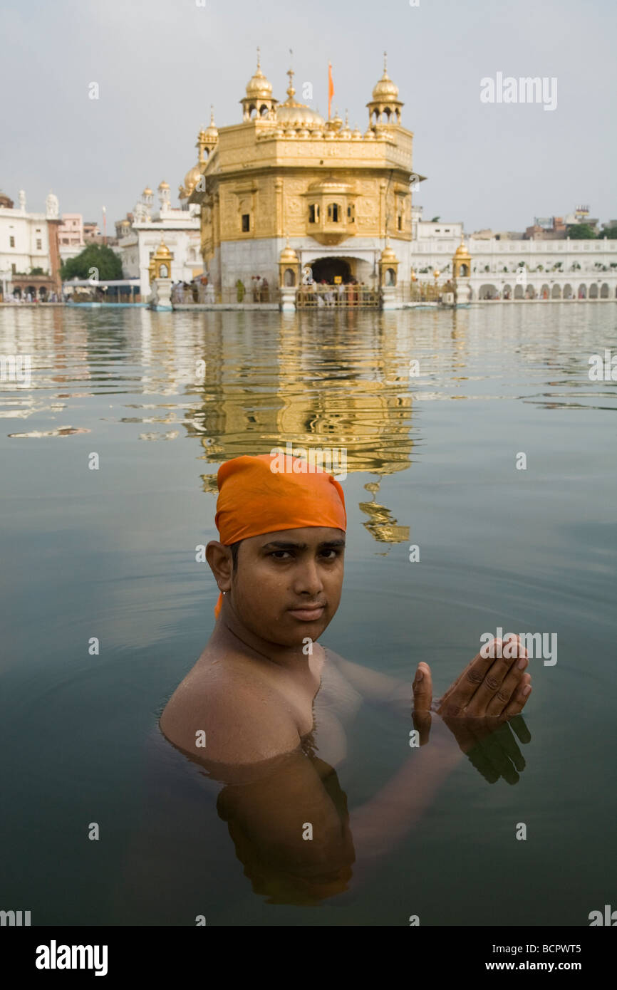 Sikh man bathes in the waters – the Sarovar (water tank) –around the ...