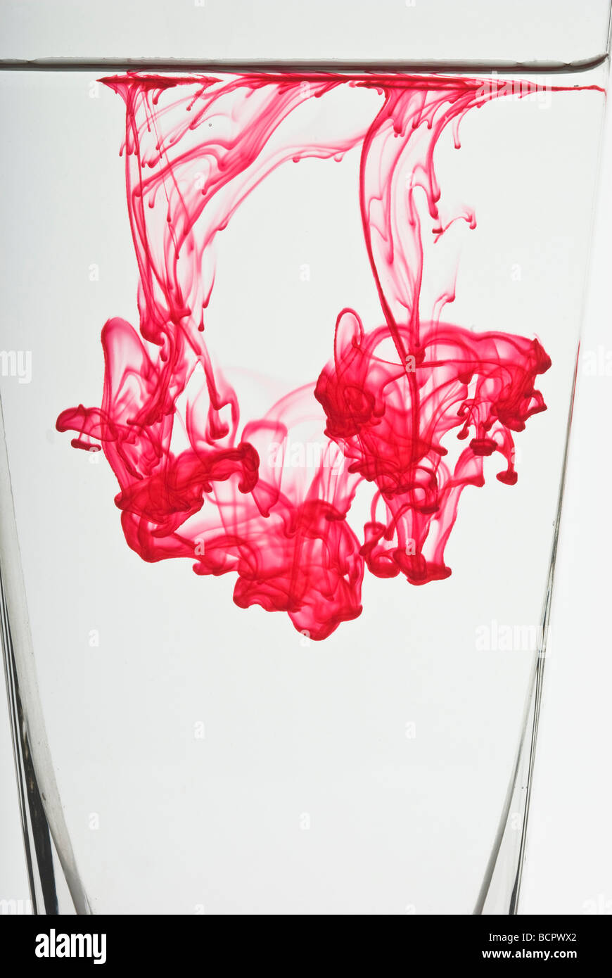 Colored food dye droplets floating in water to make abstract patterns ...