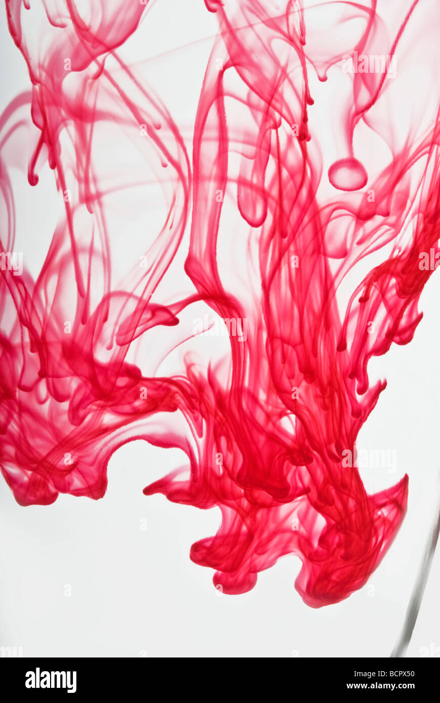Colored food dye droplets floating in water to make abstract patterns ...