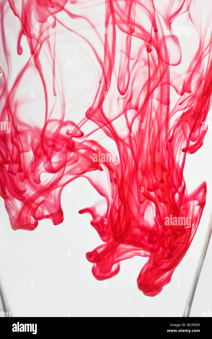 Colored food dye droplets floating in water to make abstract patterns ...