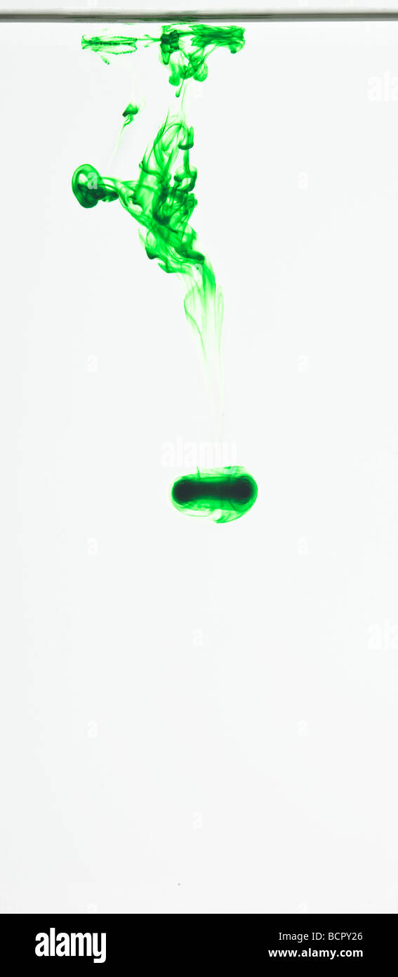 Colored food dye droplets floating in water to make abstract patterns ...