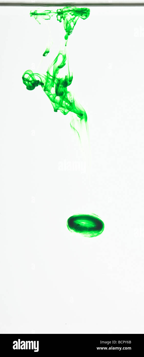 Colored food dye droplets floating in water to make abstract patterns ...