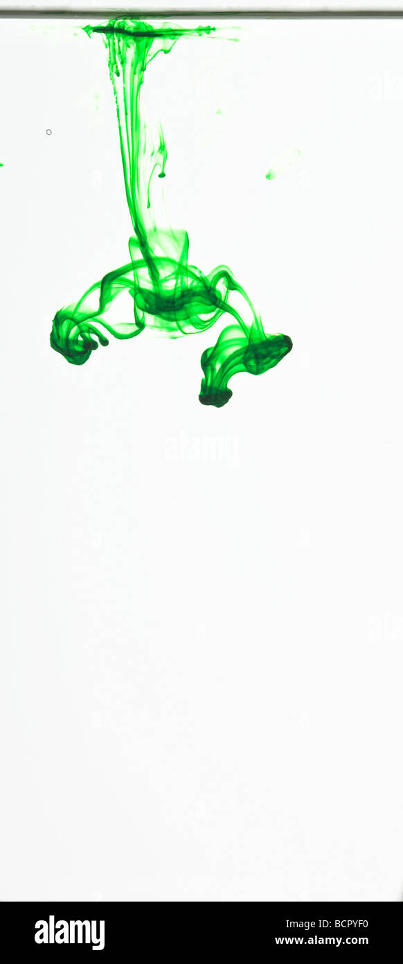 Colored food dye droplets floating in water to make abstract patterns ...