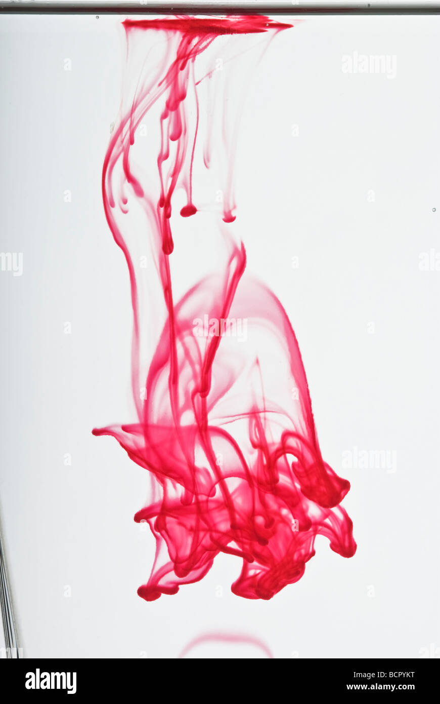 Colored food dye droplets floating in water to make abstract patterns ...