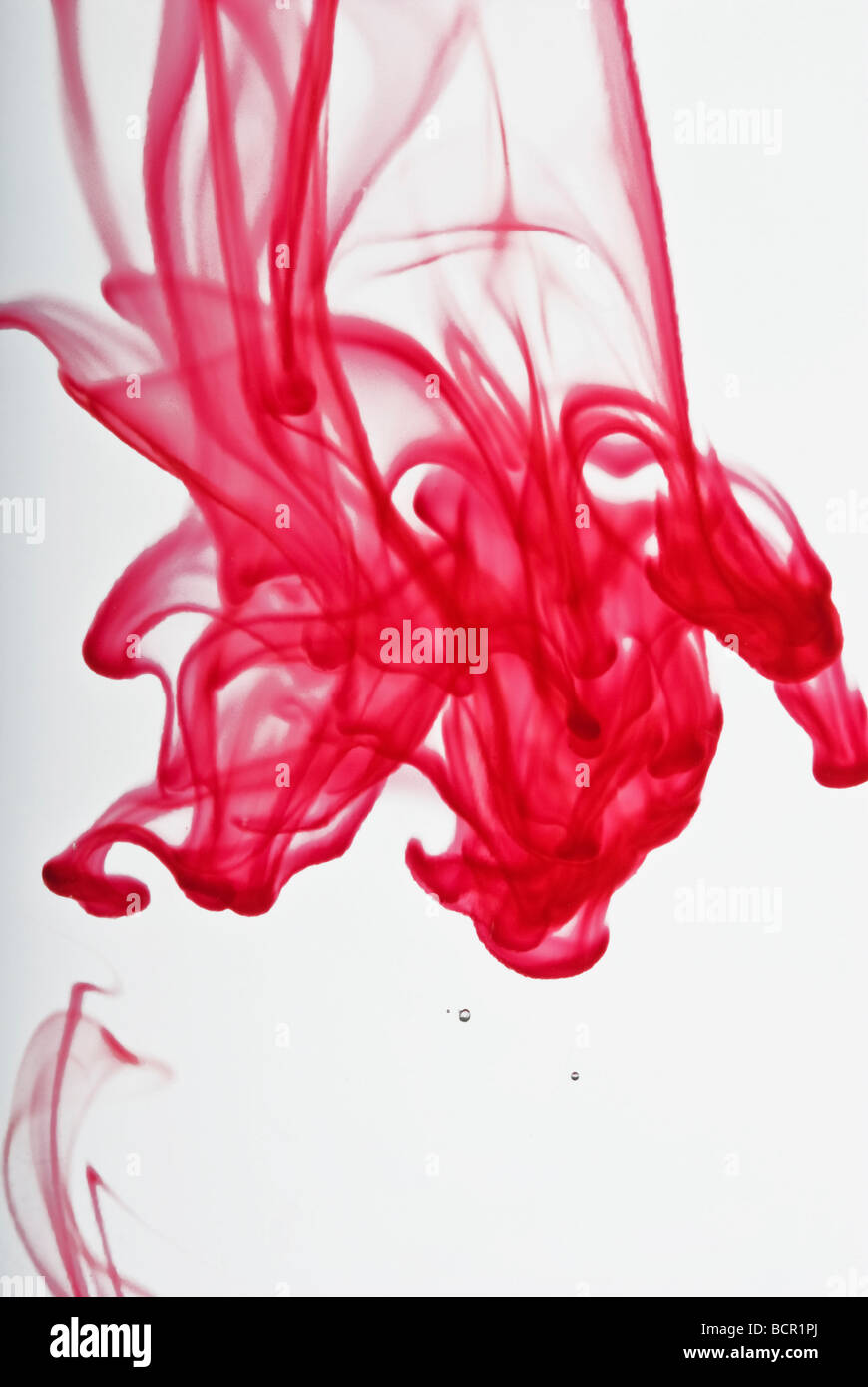 Colored food dye droplets floating in water to make abstract patterns ...