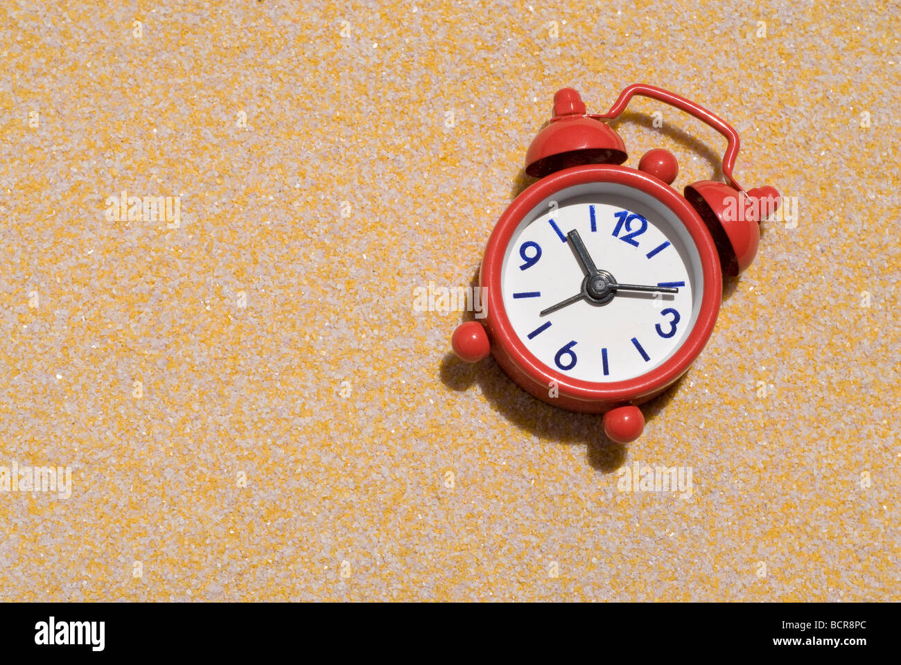 small red alarm clock at the beach Stock Photo - Alamy