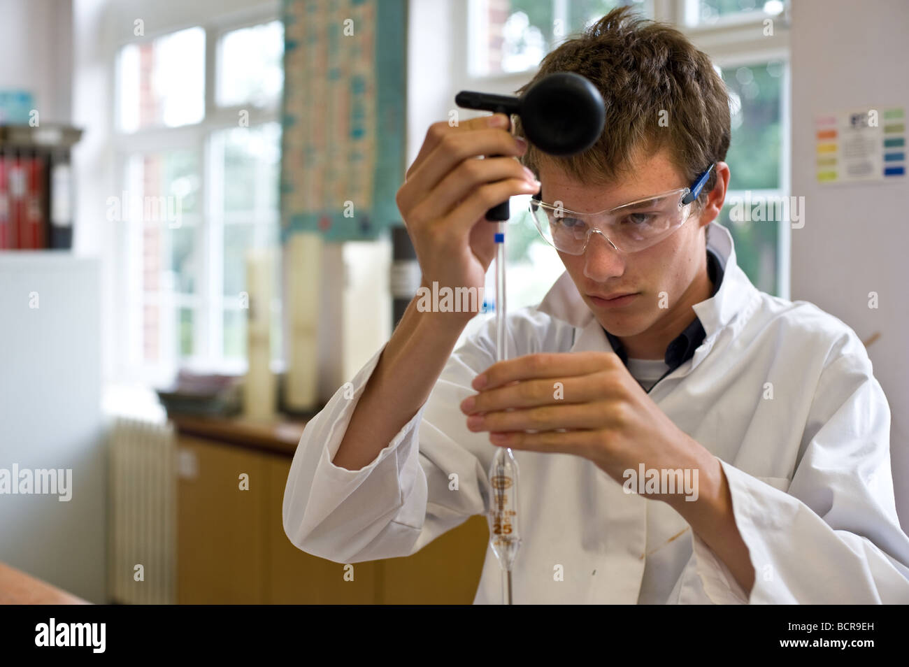 UK School A young male student conducting an experiment in a school ...