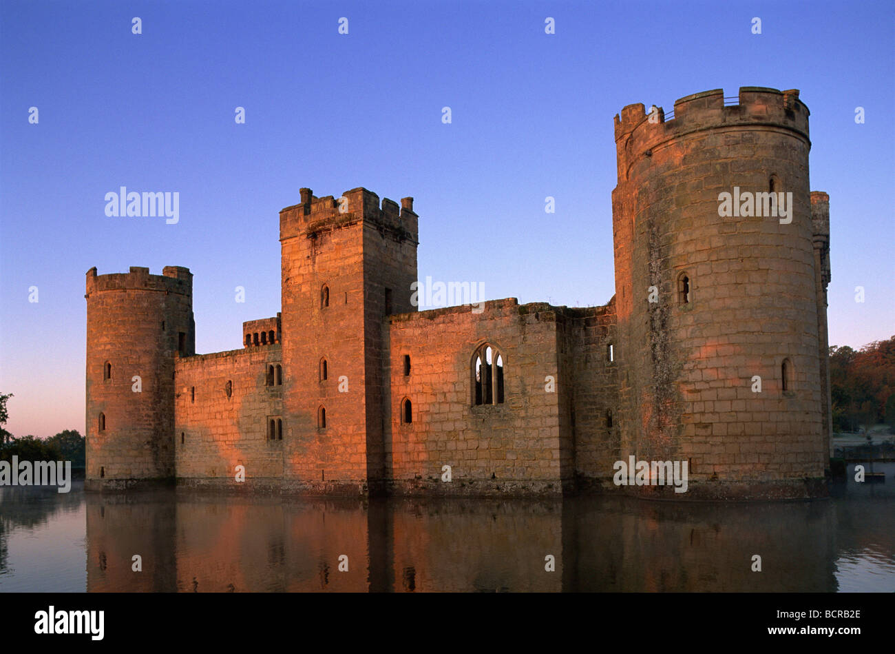 Reflection of a castle in water, Bodiam Castle, East Sussex, England ...