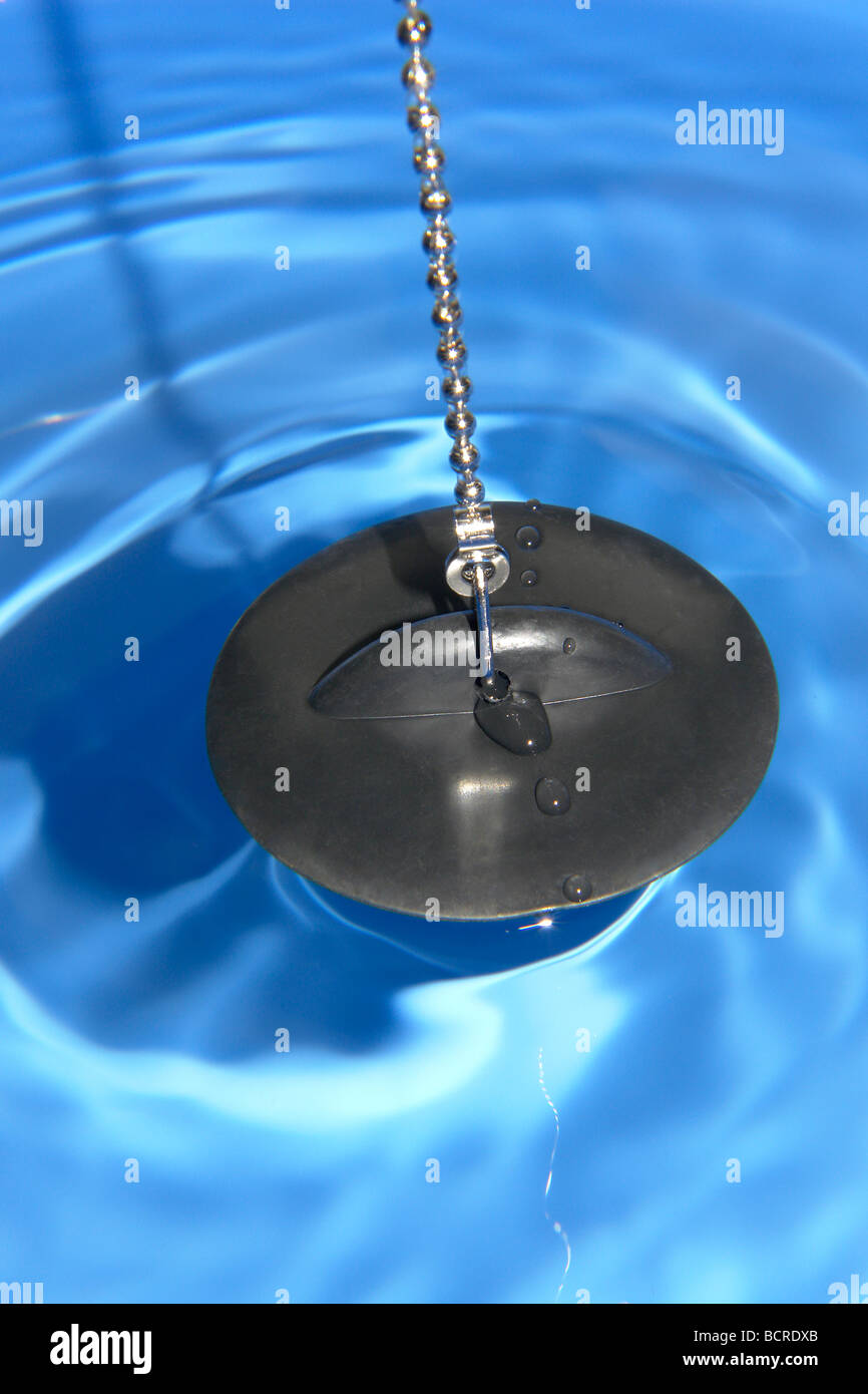 Bathtub plug on water surface Stock Photo - Alamy