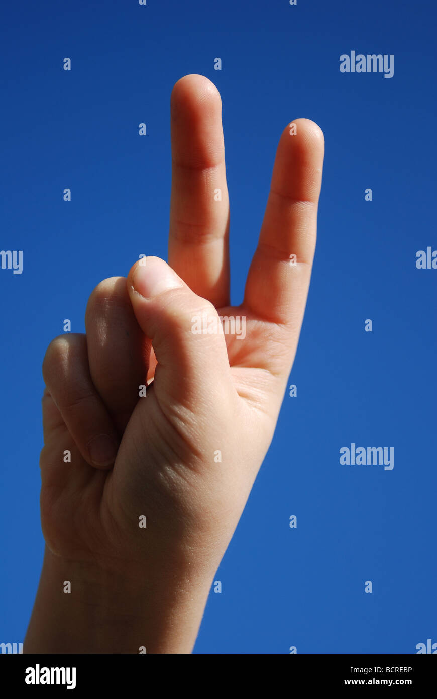 Child's hand making the V of victory Stock Photo - Alamy