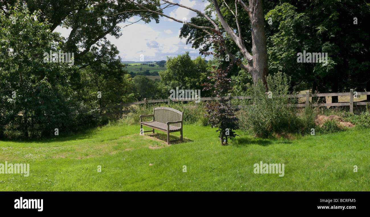 The grounds of a country estate a bench in a garden overlooking ...