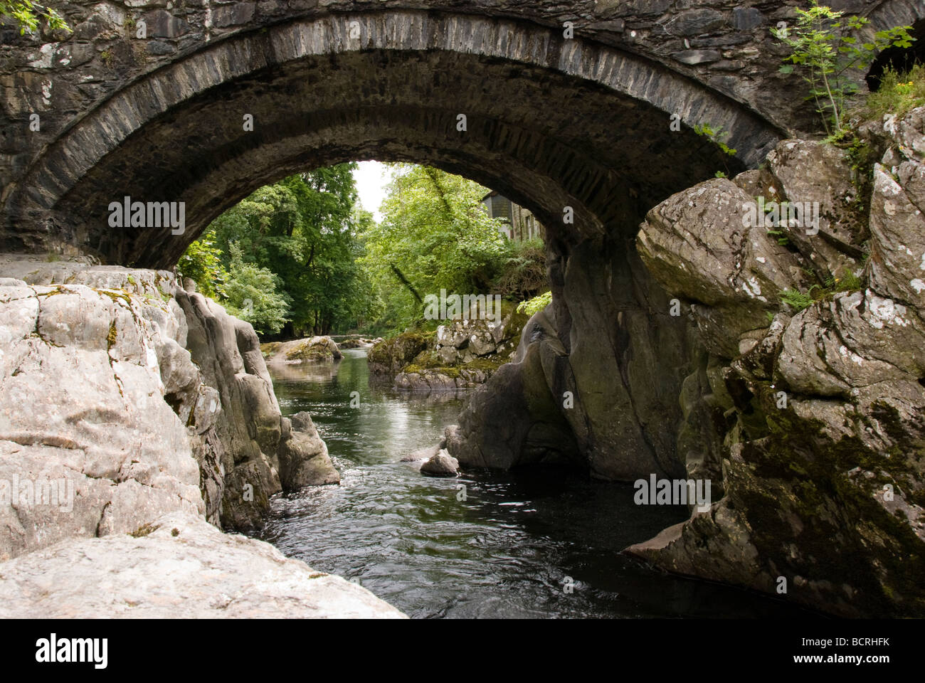 River flowing under a stone bridge at Betws-y-coed, North Wales Stock ...
