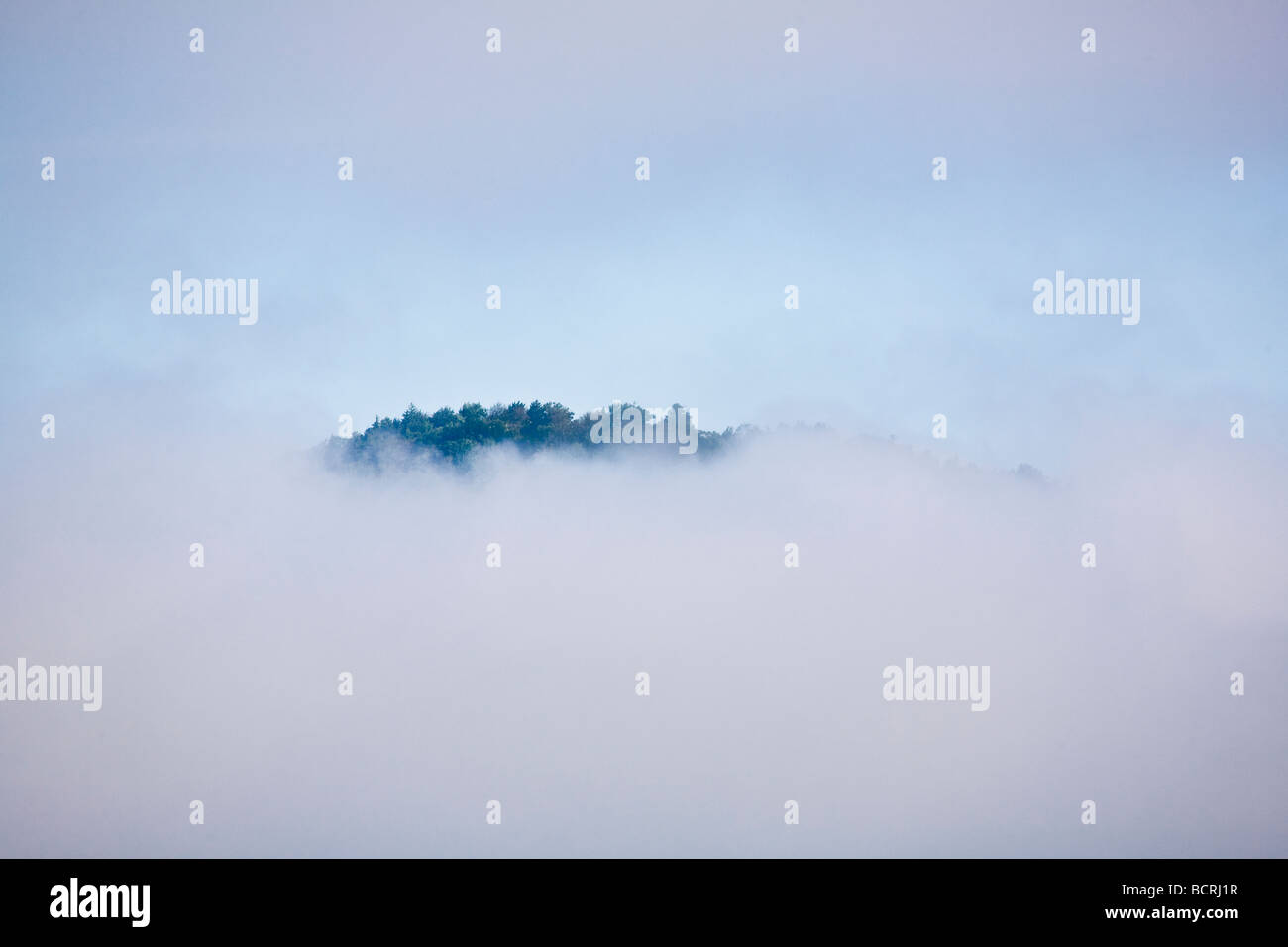 Mountain top peaking out of fog in the Adirondack Mountains of New York ...
