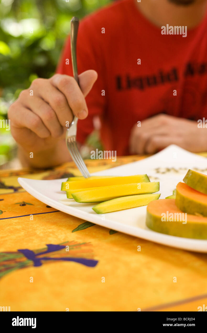 A plate of fruit with Passion fruit, Star fruit, Papaya and Mango ...