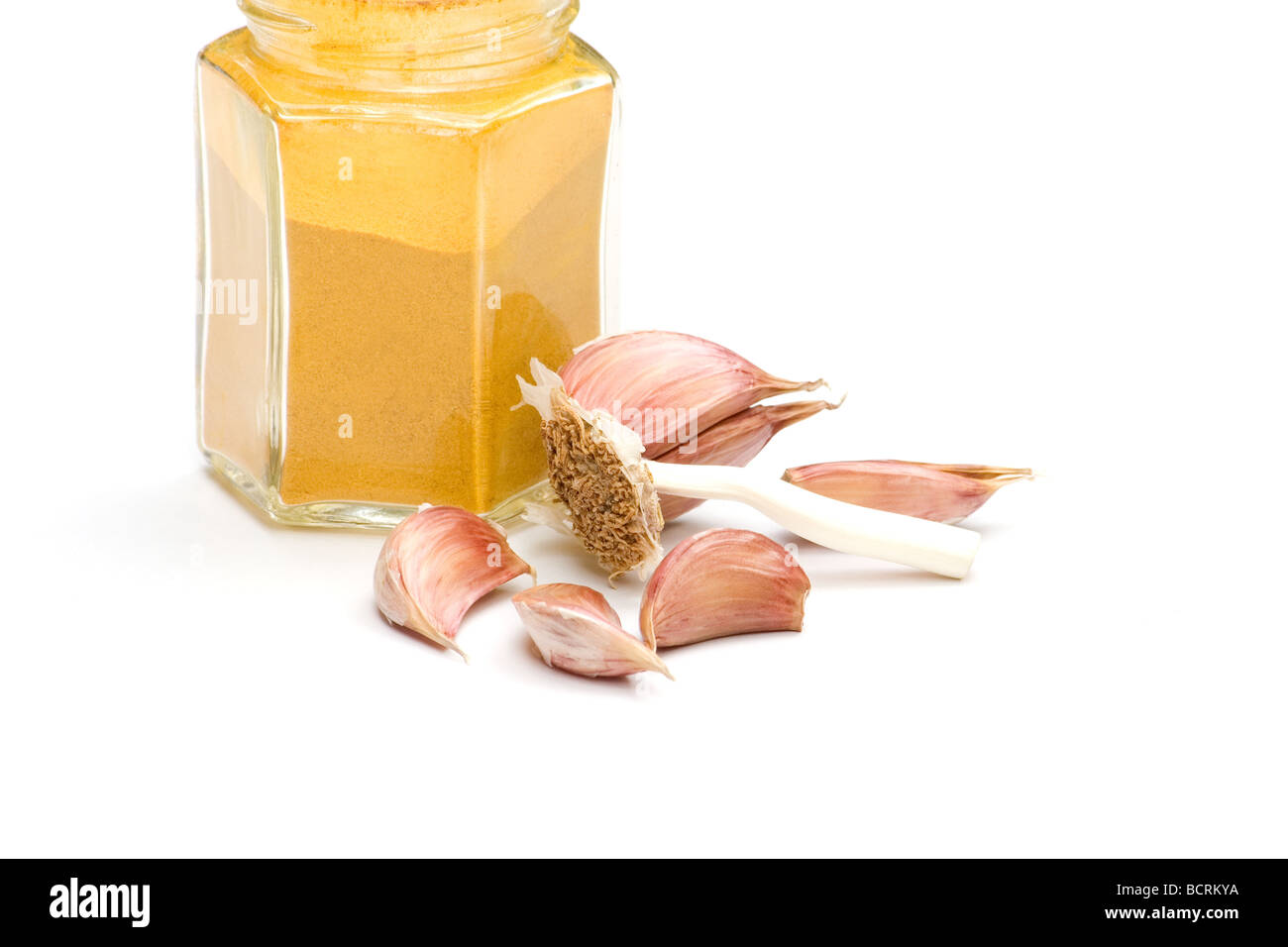 Close-up of garlic cloves and turmeric on white background Stock Photo ...