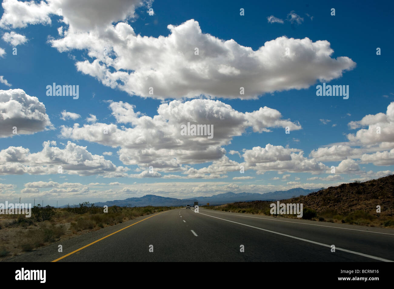 Clouds over open highway Stock Photo - Alamy