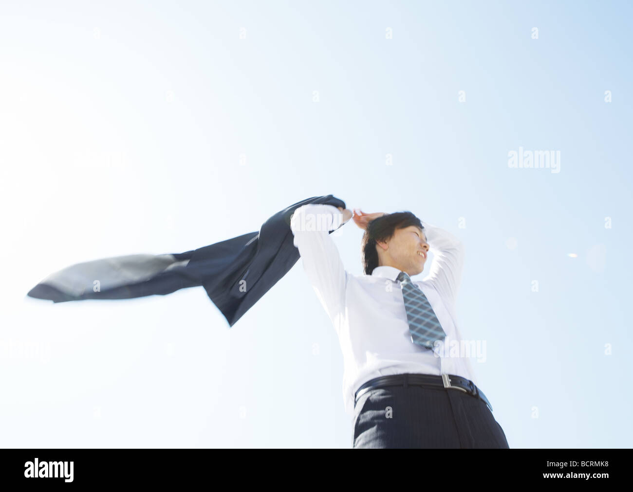 Businessman taking off his jacket Stock Photo - Alamy