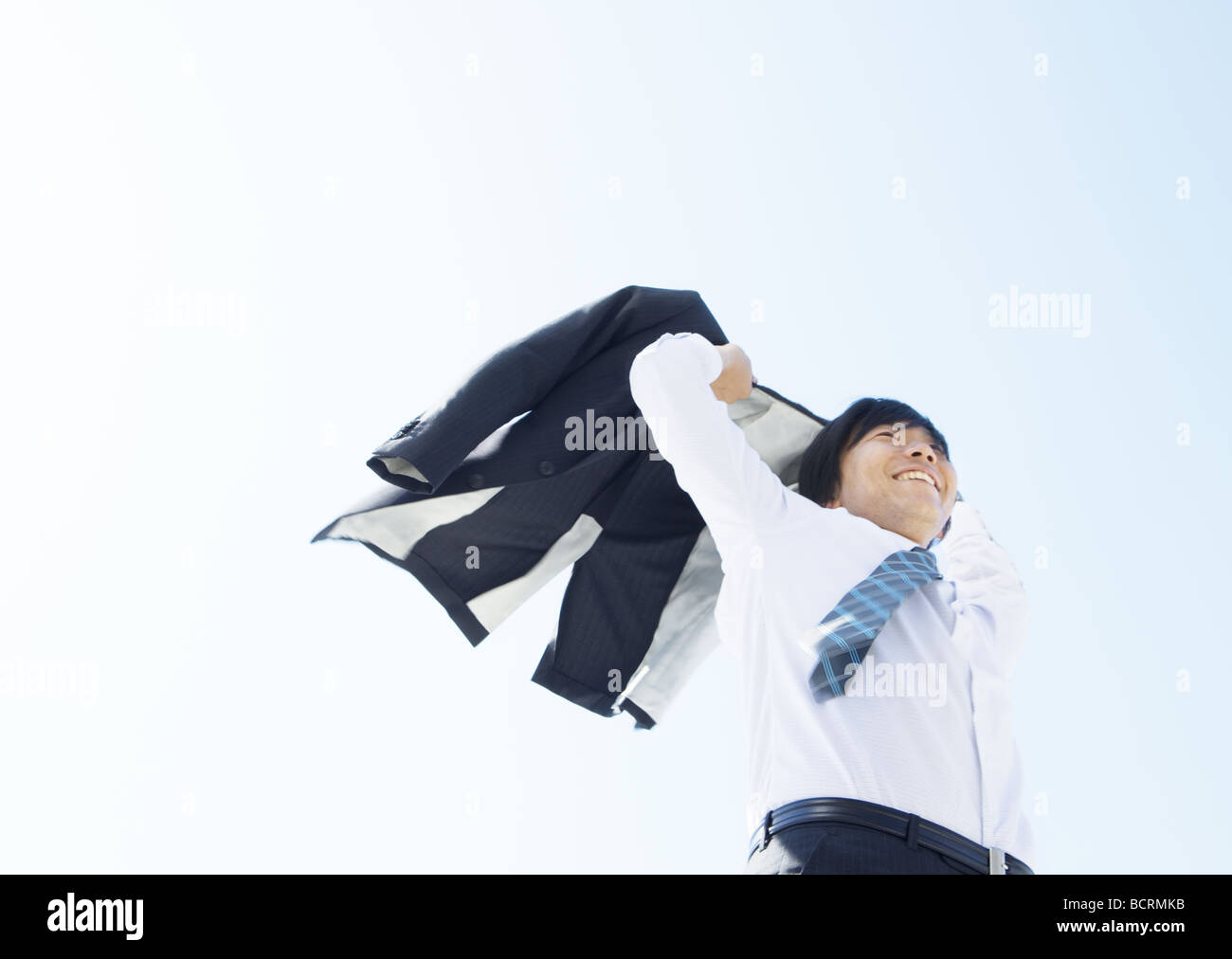 Businessman taking off his jacket Stock Photo - Alamy