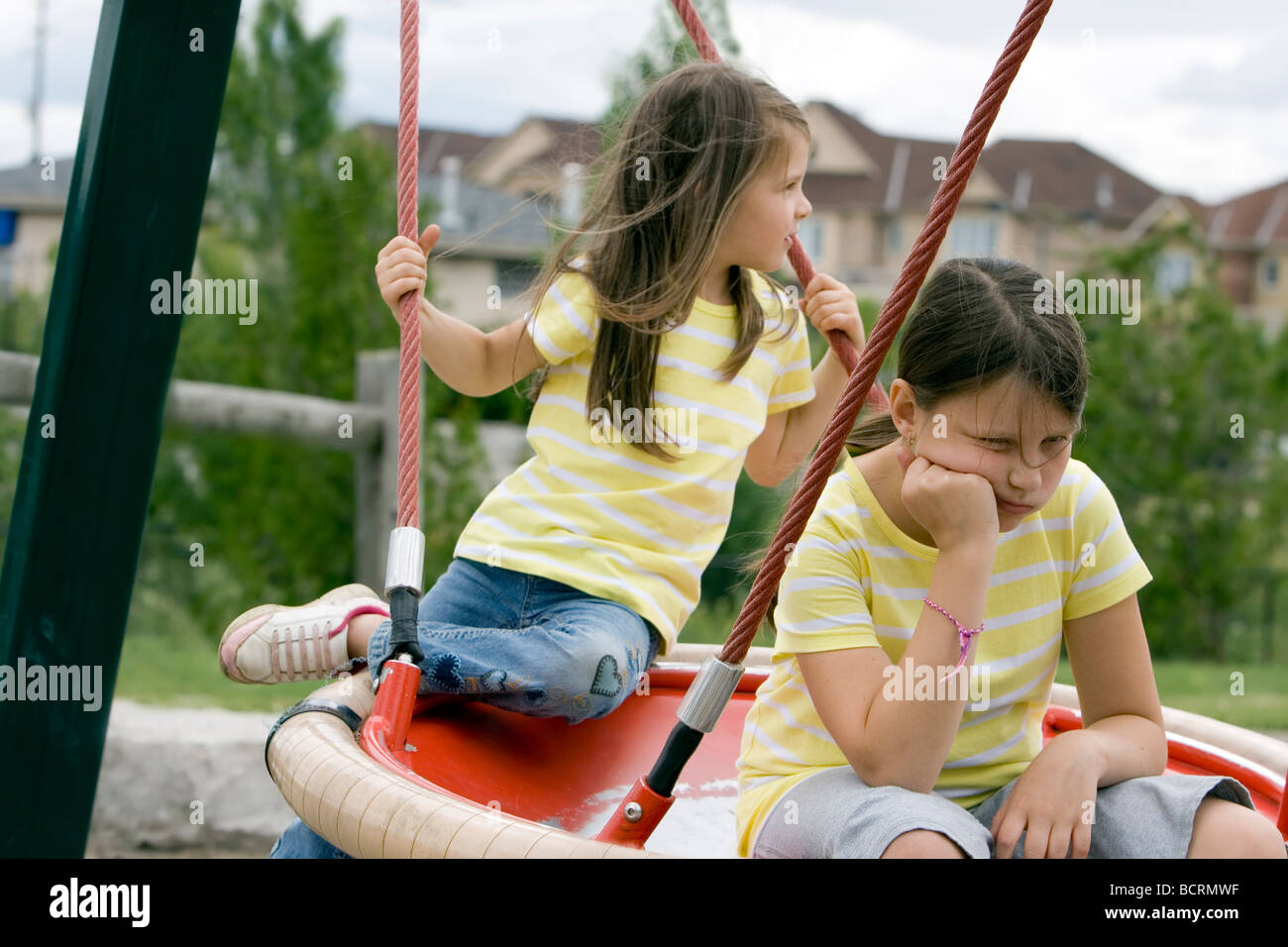 2 sisters on swing Stock Photo - Alamy