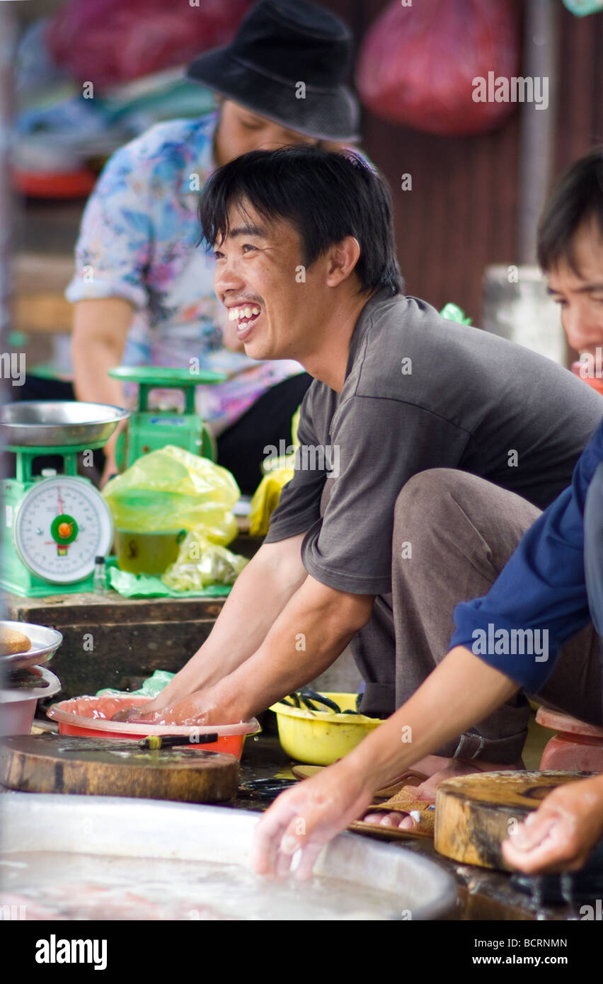 Man rinsing fish at a local market in Ho Chi Minh City Vietnam Stock ...