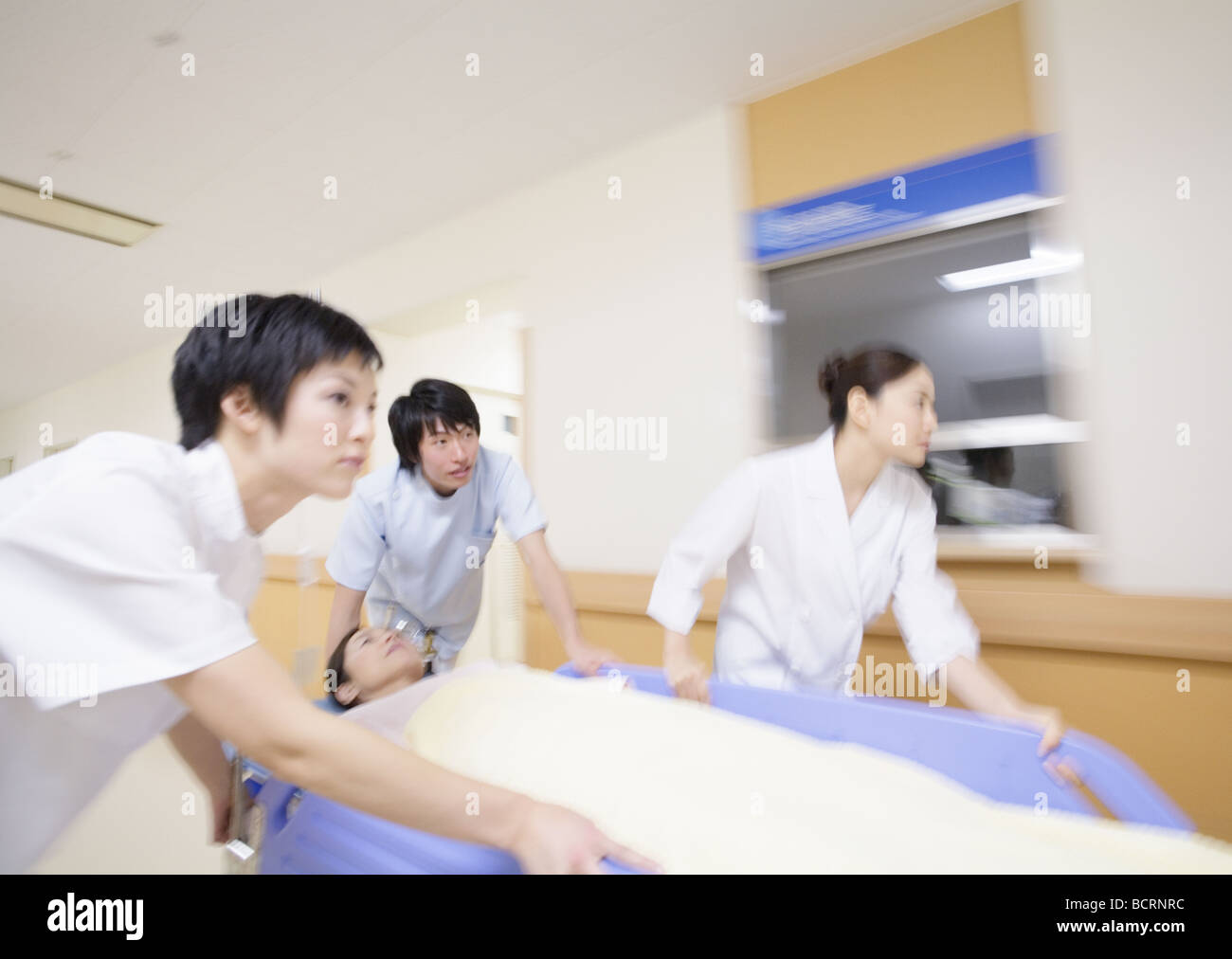 Doctor and nurse carrying patient Stock Photo - Alamy