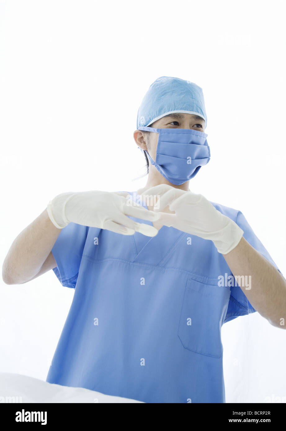 Surgeon wearing surgical gown Stock Photo - Alamy