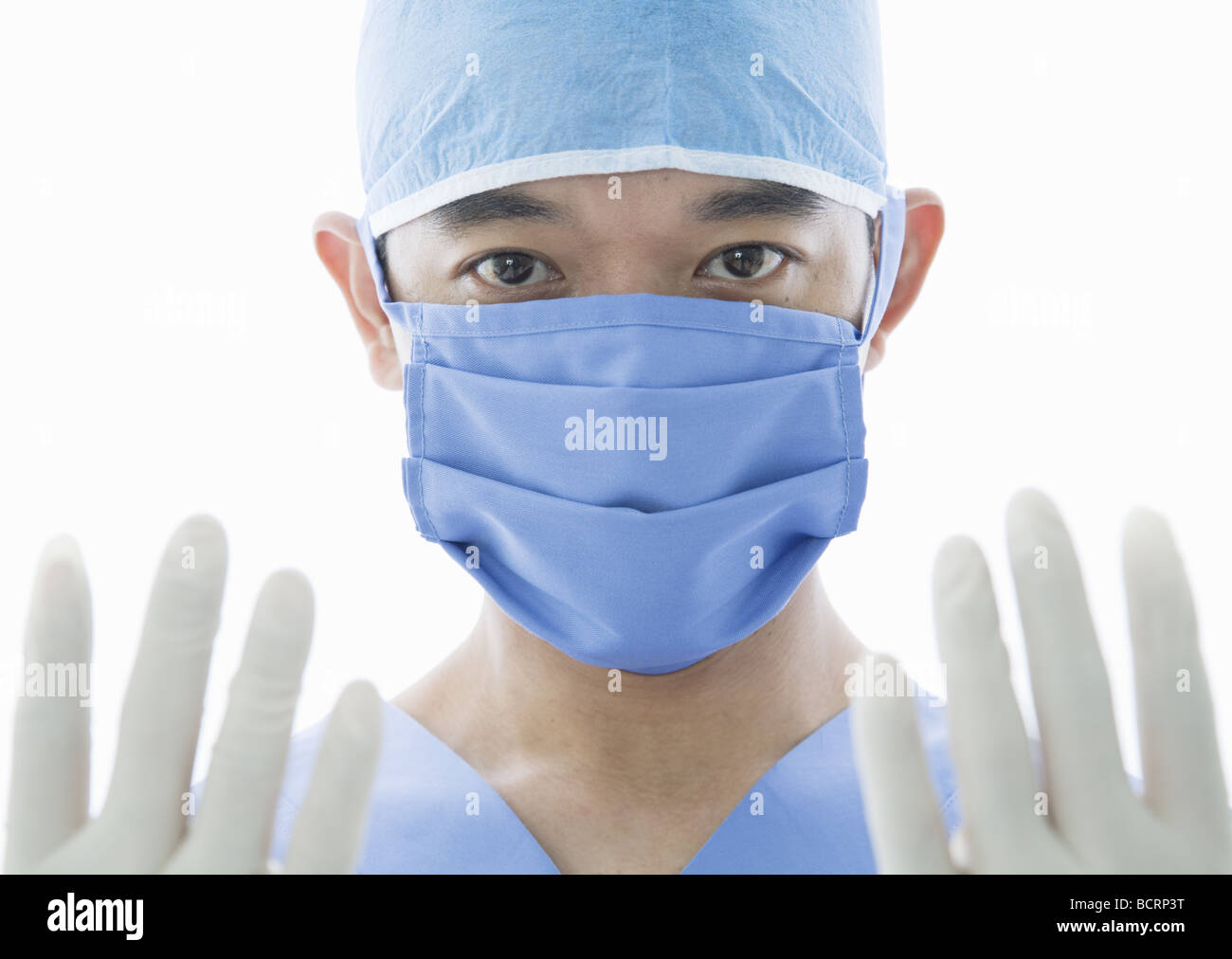 Surgeon wearing surgical gown Stock Photo - Alamy