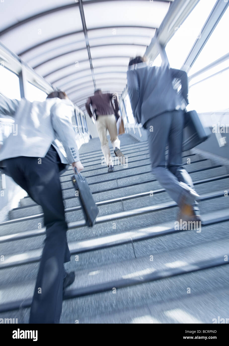 Businessmen running up stairs Stock Photo - Alamy