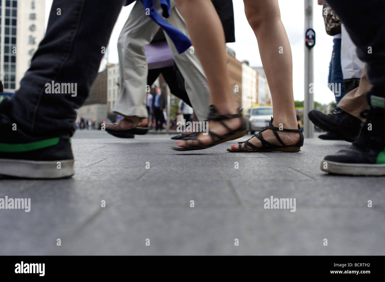 Feet walking on footpath Connelly Street Dublin Ireland Stock Photo - Alamy