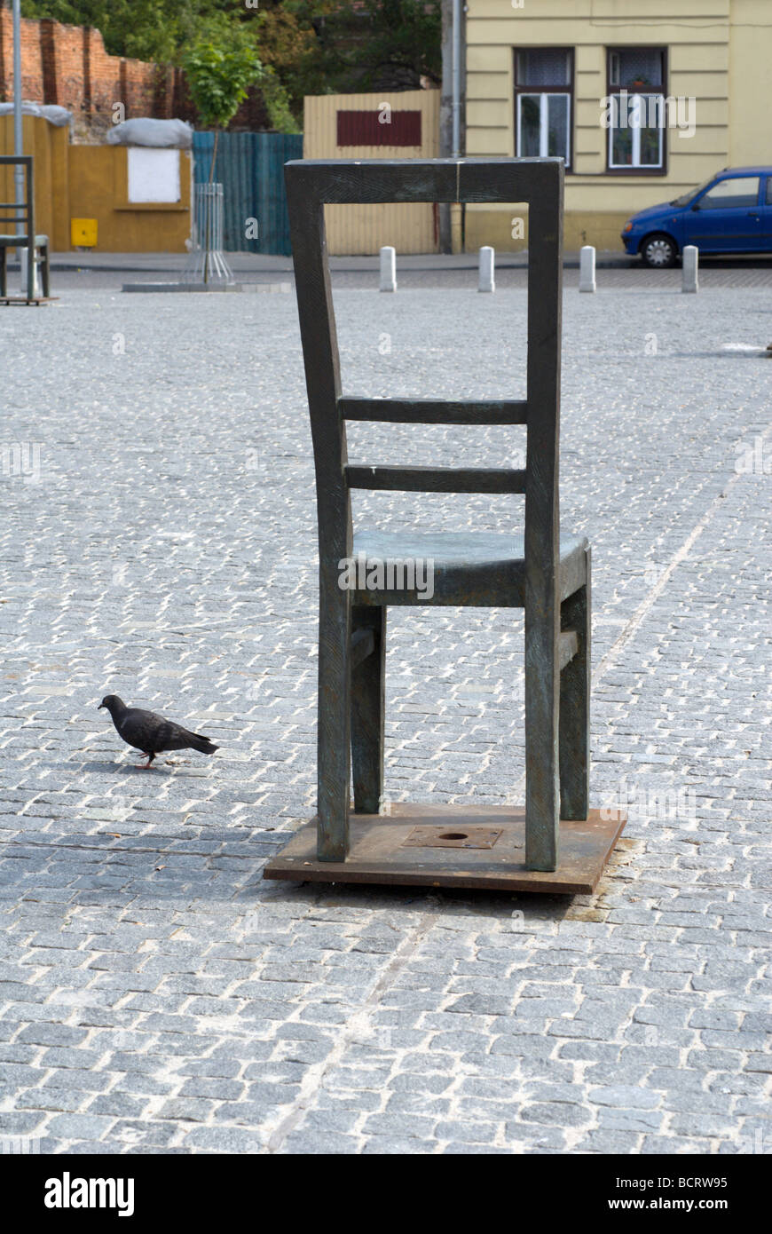 Holocaust memorial sculpture of empty chair in square in Podgorze ...