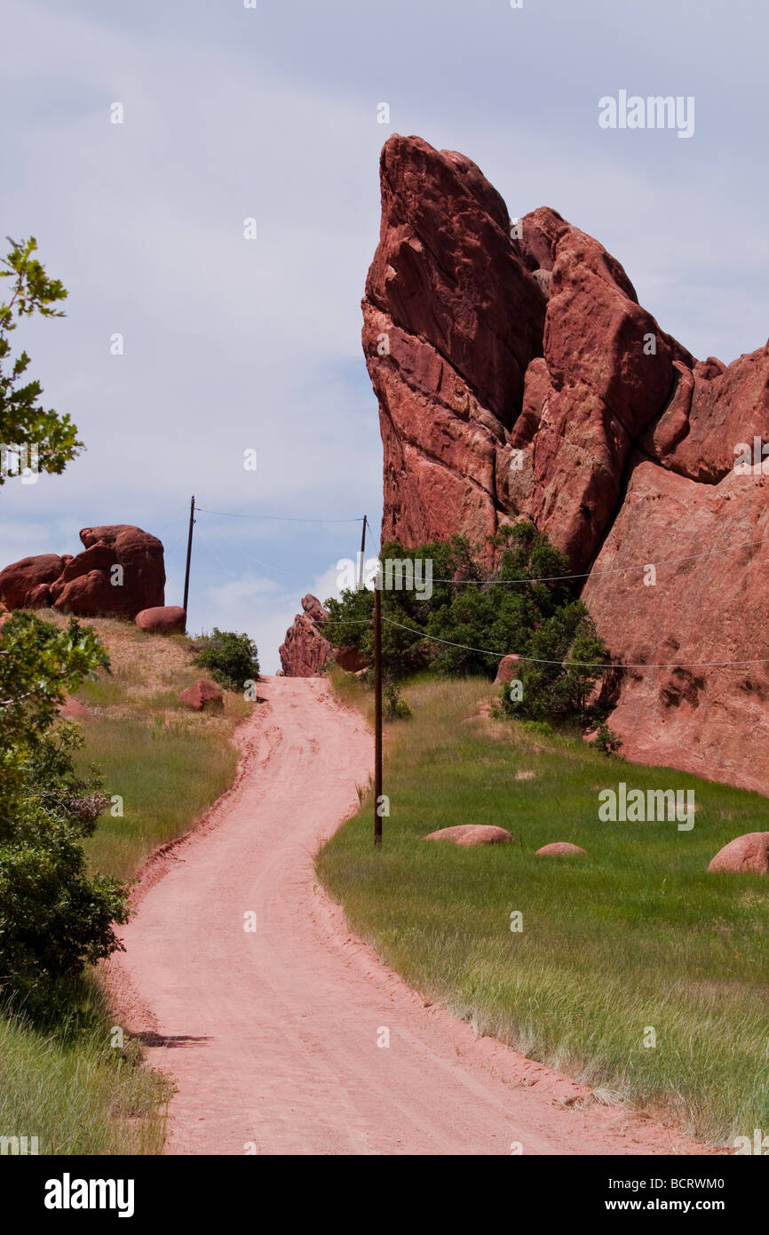 Dirt road winding through rock outcropping Stock Photo - Alamy