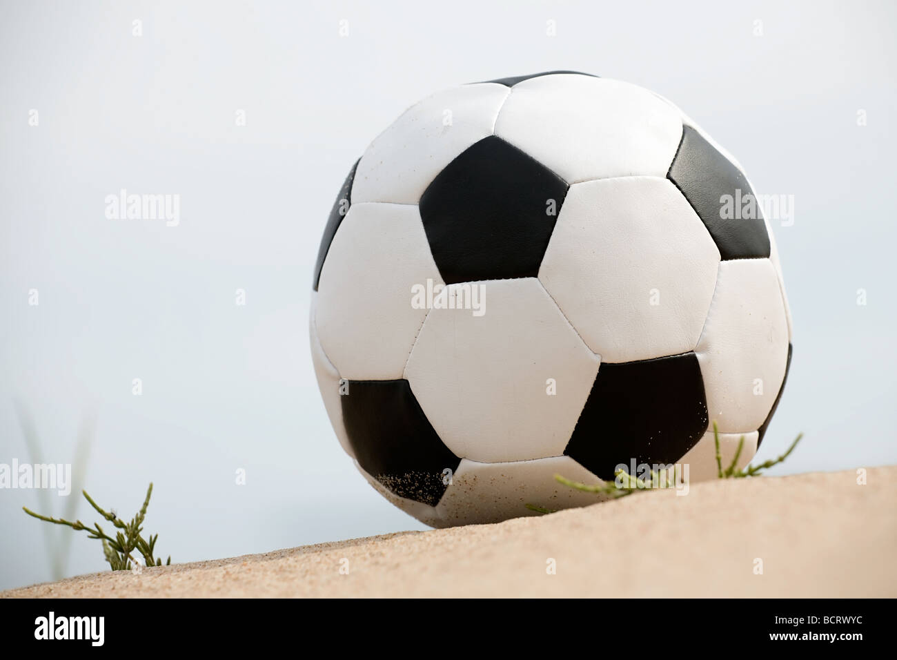 football ball on sandy hill Stock Photo - Alamy