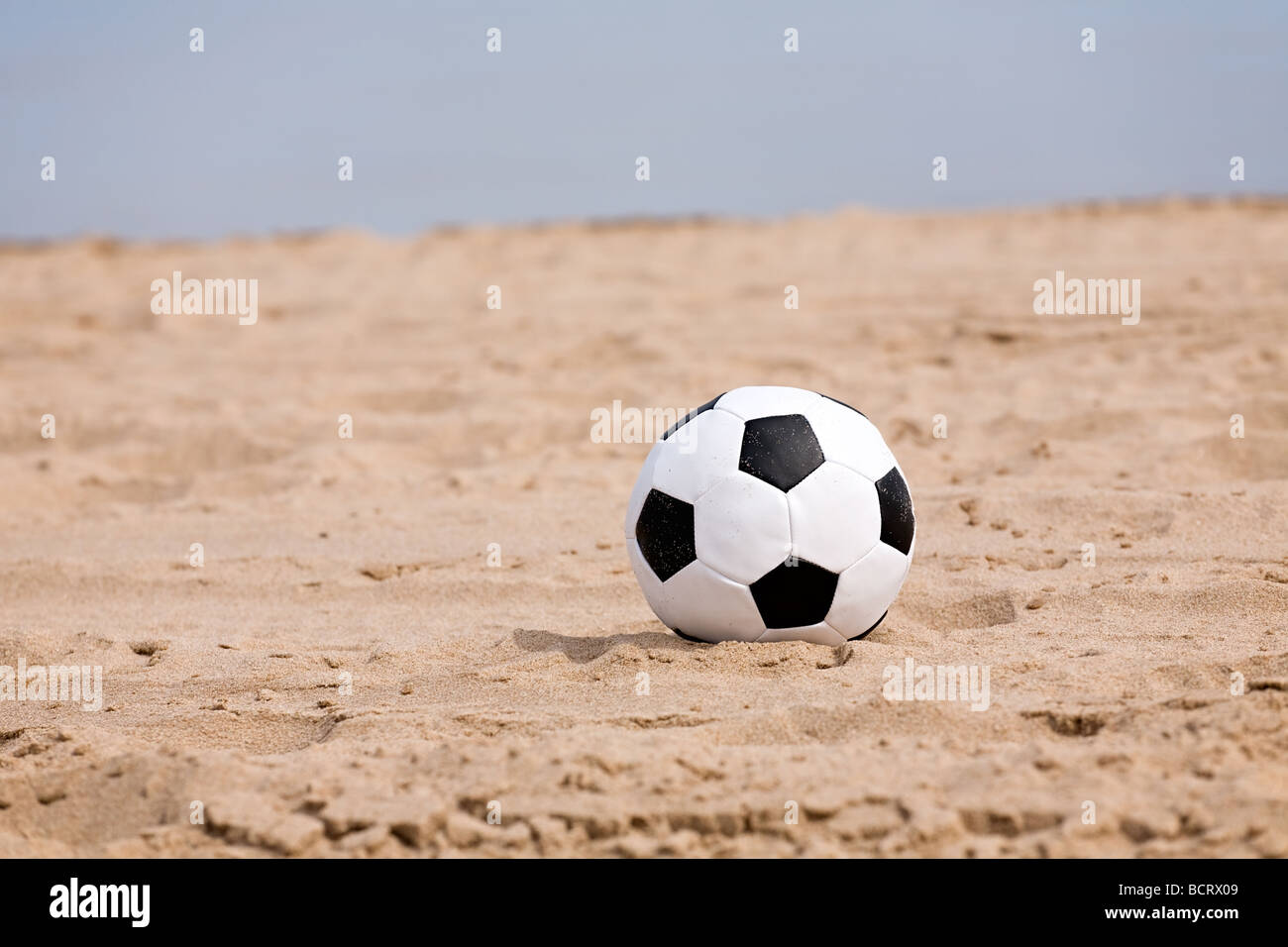 soccer leather ball on sandy beach background Stock Photo - Alamy