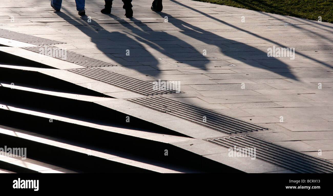 long shadows of three people walking in the UK Stock Photo - Alamy
