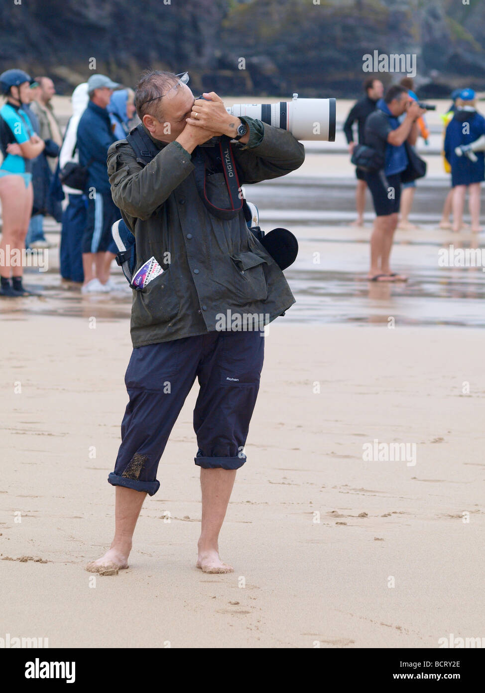 Photographer on a beach photographing a sporting event Stock Photo - Alamy