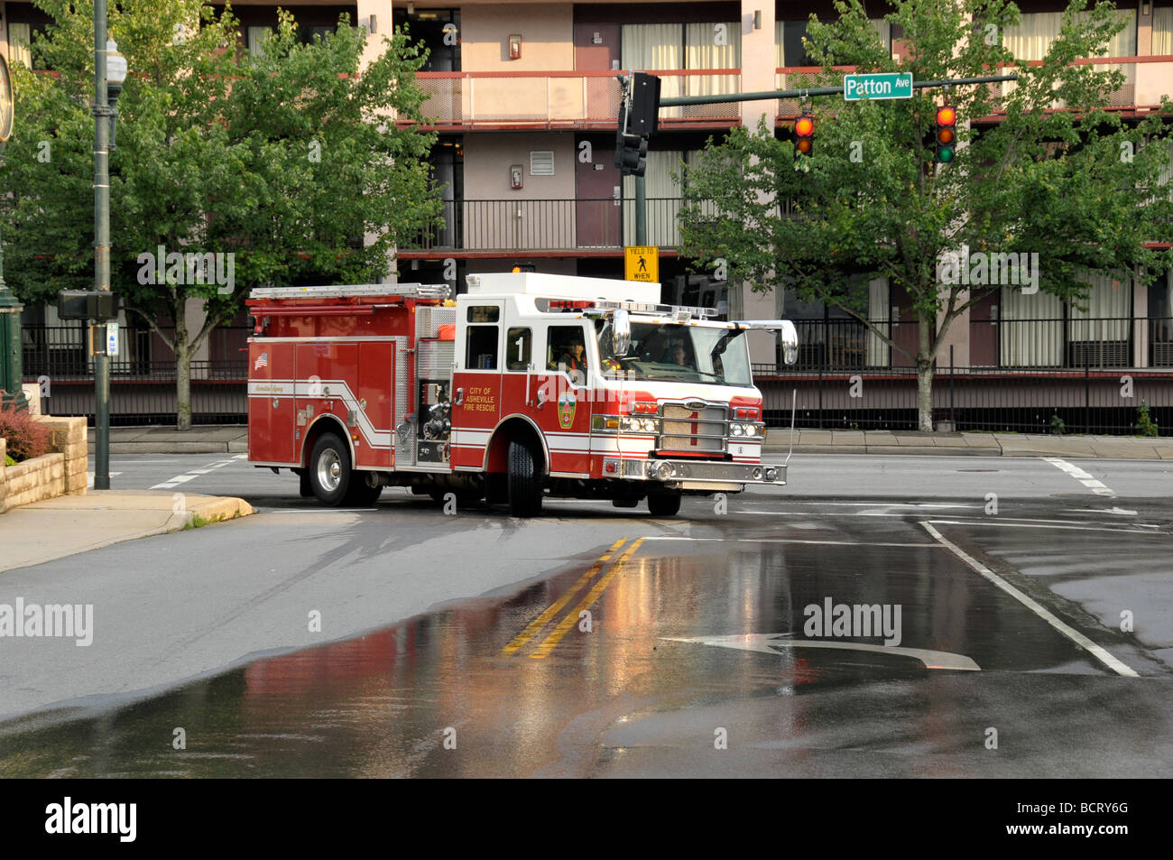Fire engine coming around corner Stock Photo - Alamy