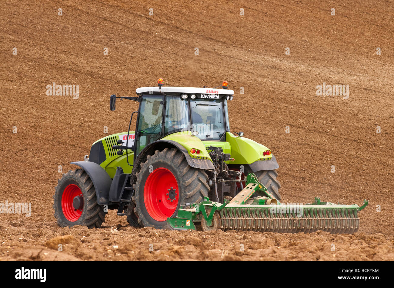 Claas Axion 820 tractor harrowing plowed field, sud-Touraine, France ...