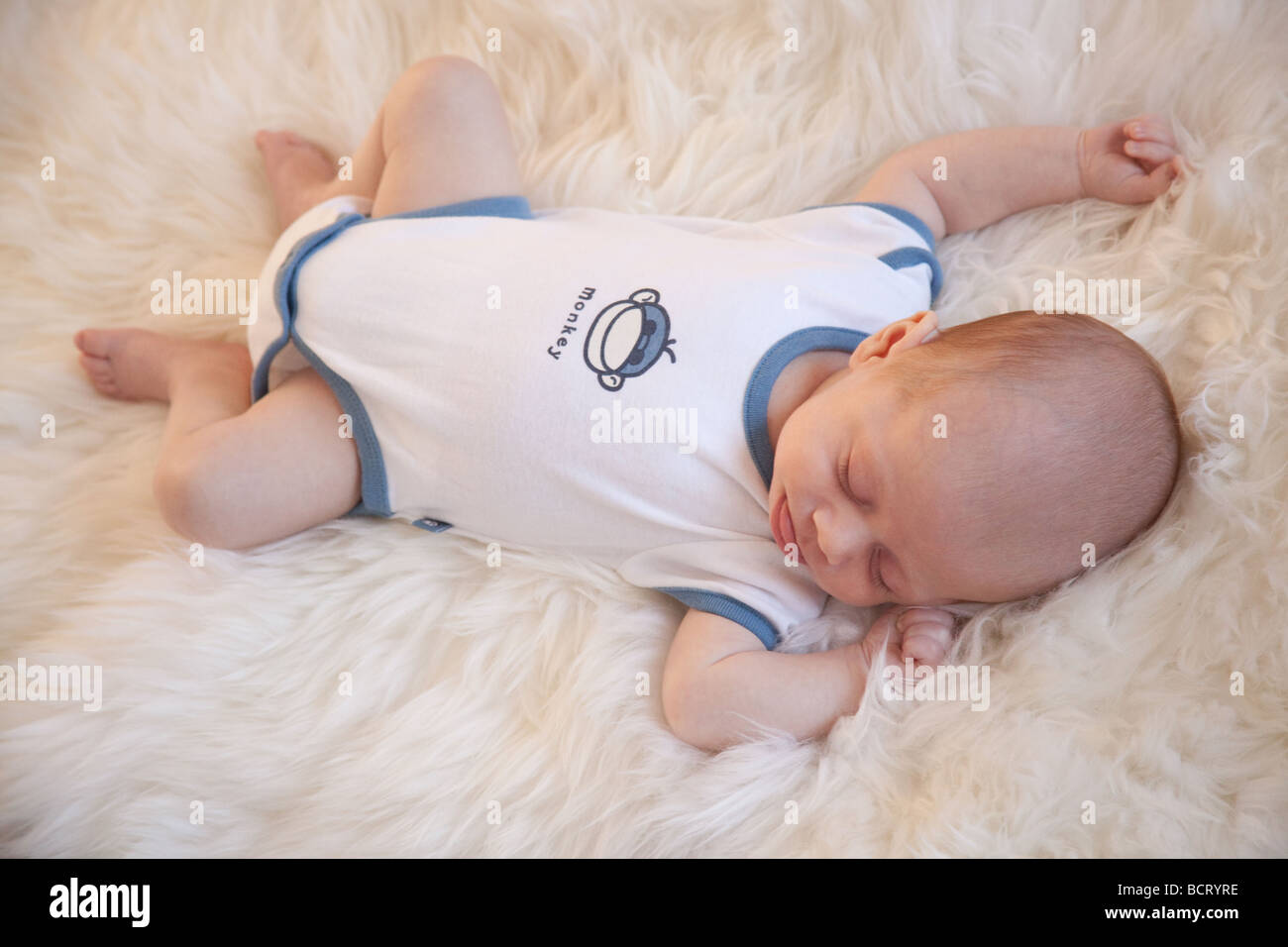 Newborn baby boy sleeping on a sheepskin rug, London, England Stock ...