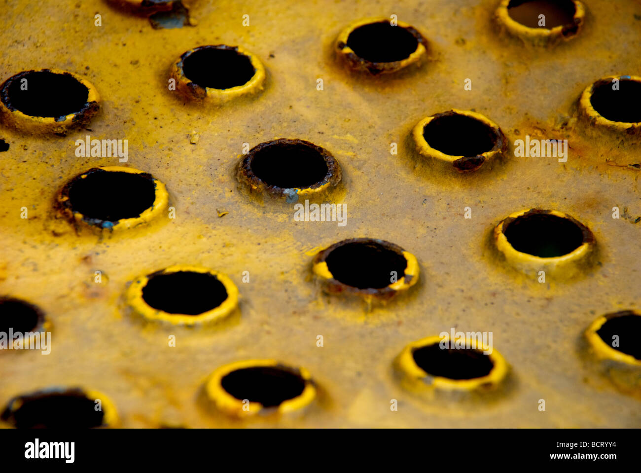 yellow steel grate with holes Stock Photo - Alamy