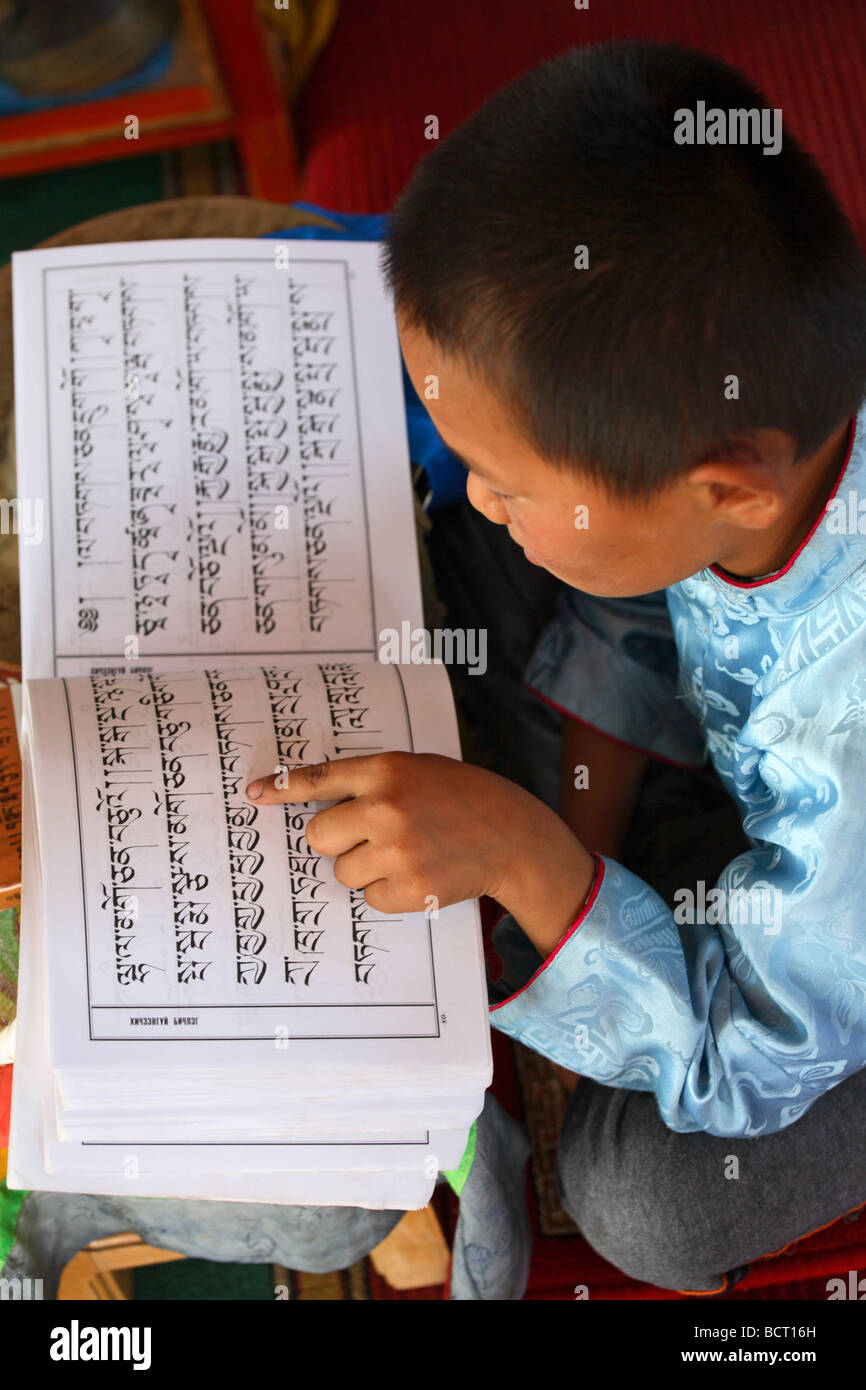 Child monk reading a pray book , Mongolia Stock Photo - Alamy