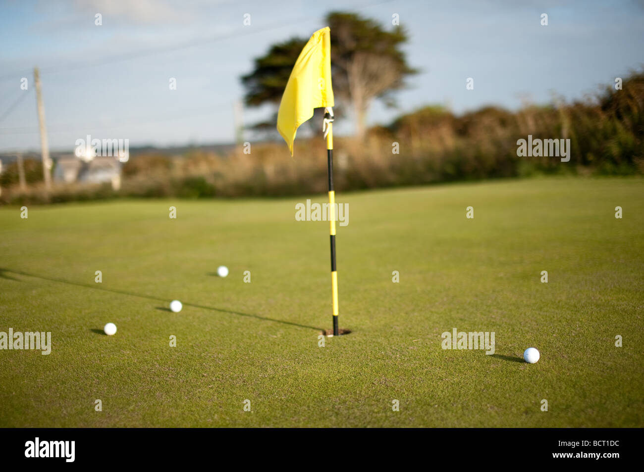Golf course, flags and balls Stock Photo - Alamy